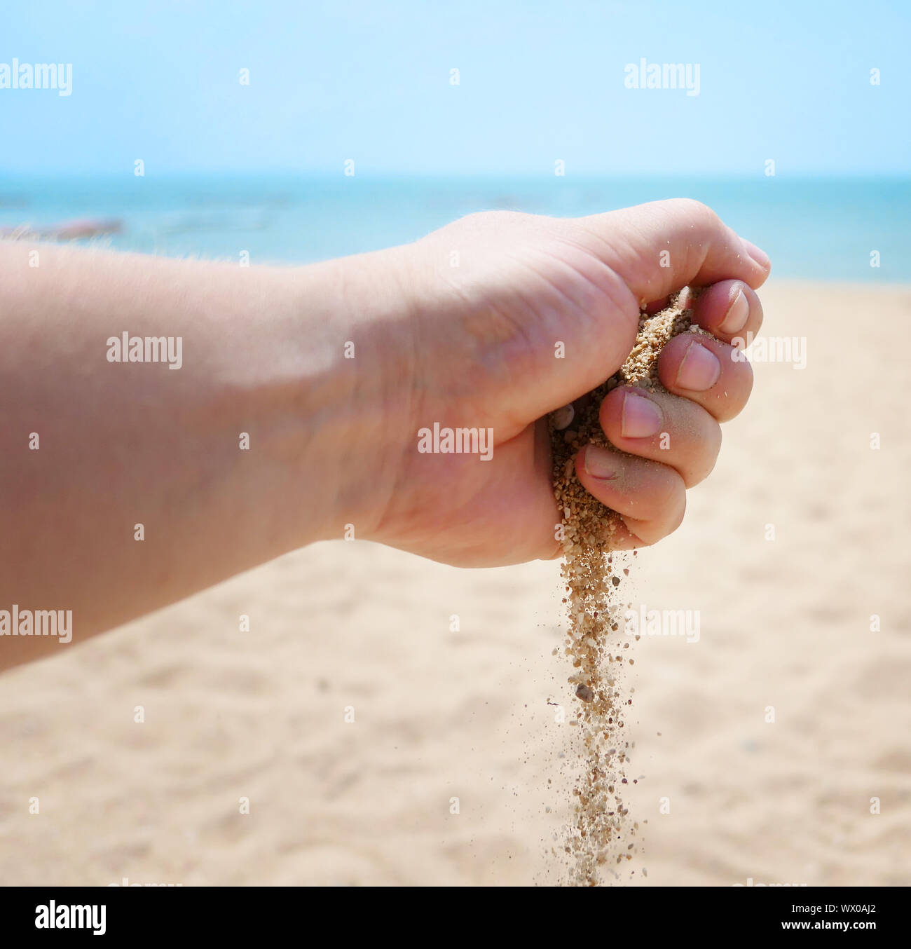 Sand in hand Stock Photo - Alamy
