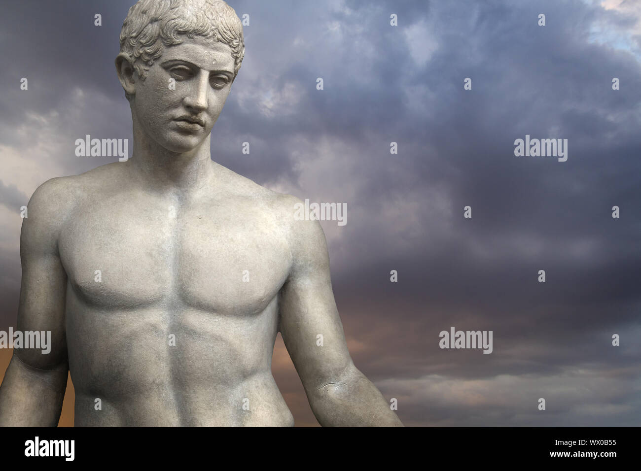 Greek Sculpture. Young Adonis bronze statue with blue sky background ...