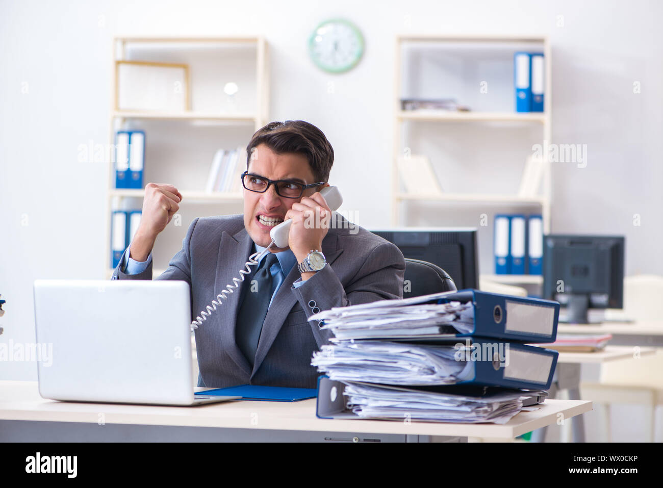 Desperate sad employee tired at his desk in call center Stock Photo - Alamy