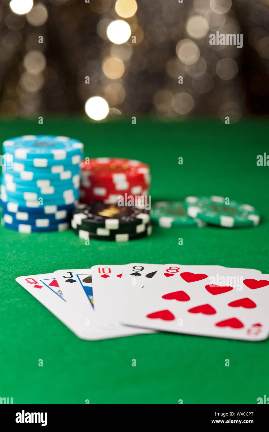 Straight flush, with chips in front of a gold glitter background Stock ...