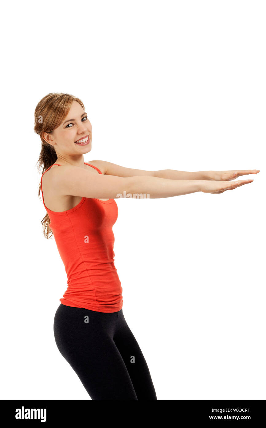 young happy fitness woman exercising with her arms on white background ...
