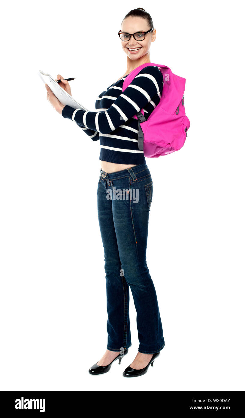 Teenage college student writing notes, full length portrait Stock Photo ...