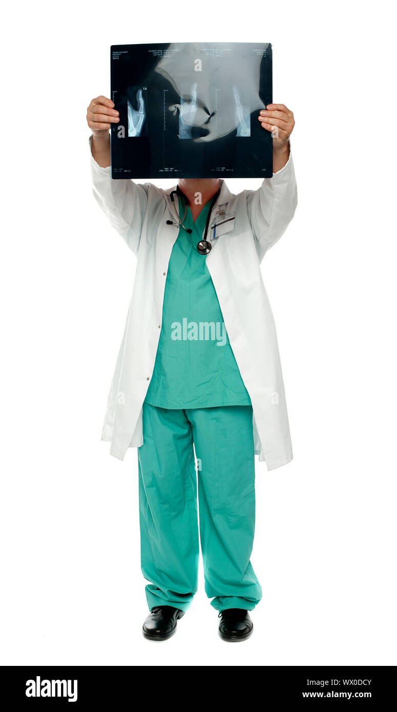Medical expert hiding his face with x-ray report, full length portrait ...