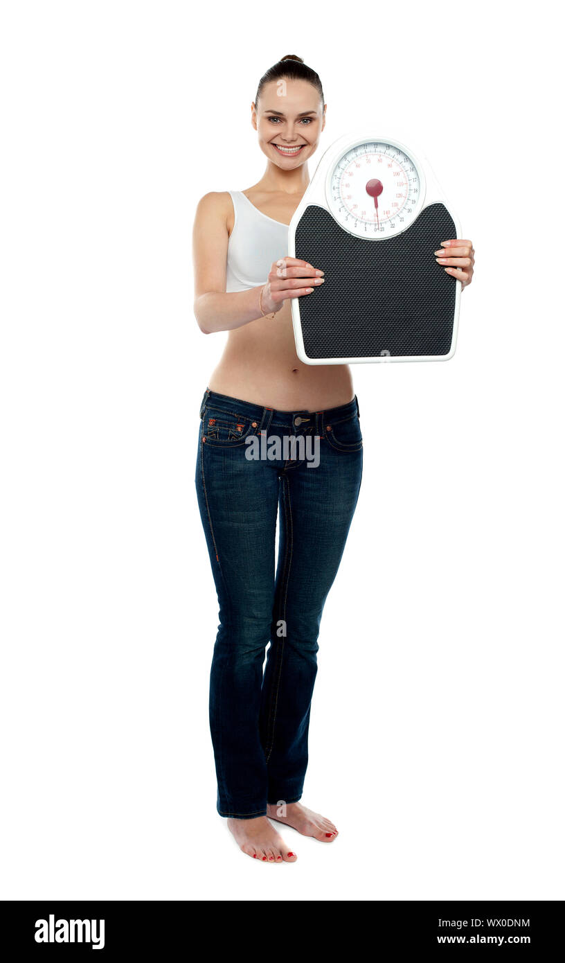 Full frame woman holding a scale against white background Stock Photo ...