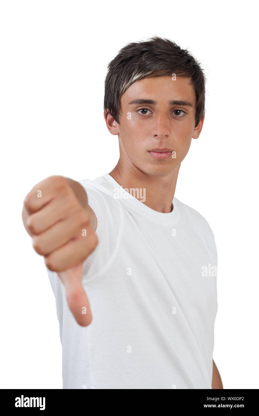 young swarthy man with brown eyes gives the thumbs down gesture on grey ...