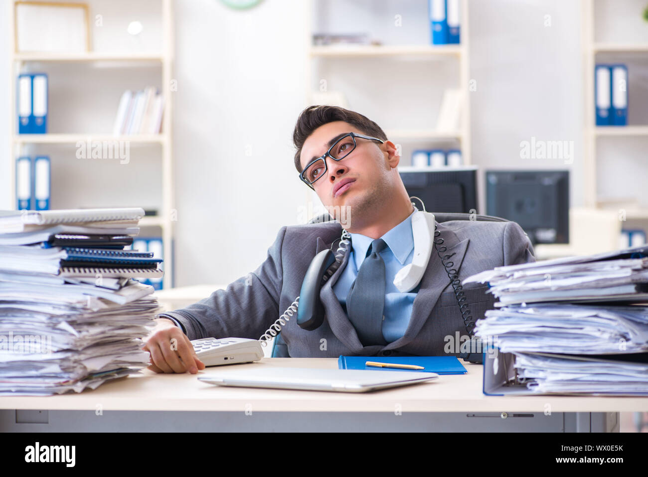 Desperate sad employee tired at his desk in call center Stock Photo - Alamy