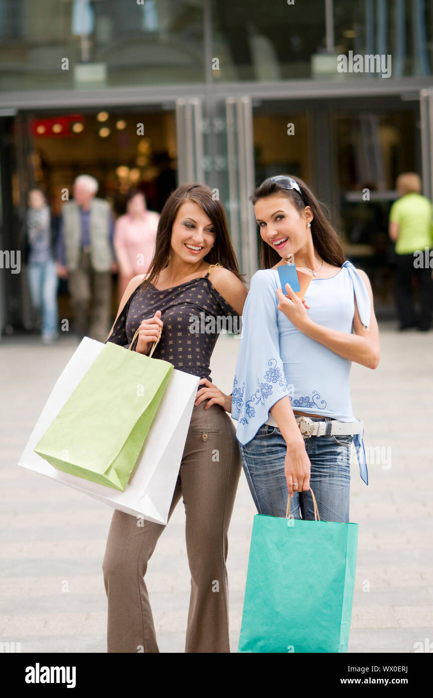 two girls enjoying her puchases and showing the credit cards Stock ...