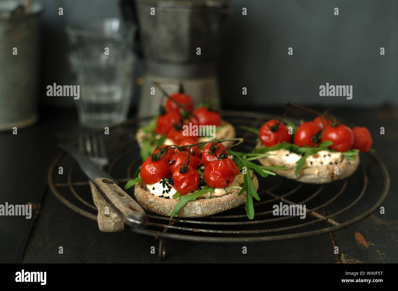 toast roll with cream cheese, rocket and tomatos Stock Photo - Alamy