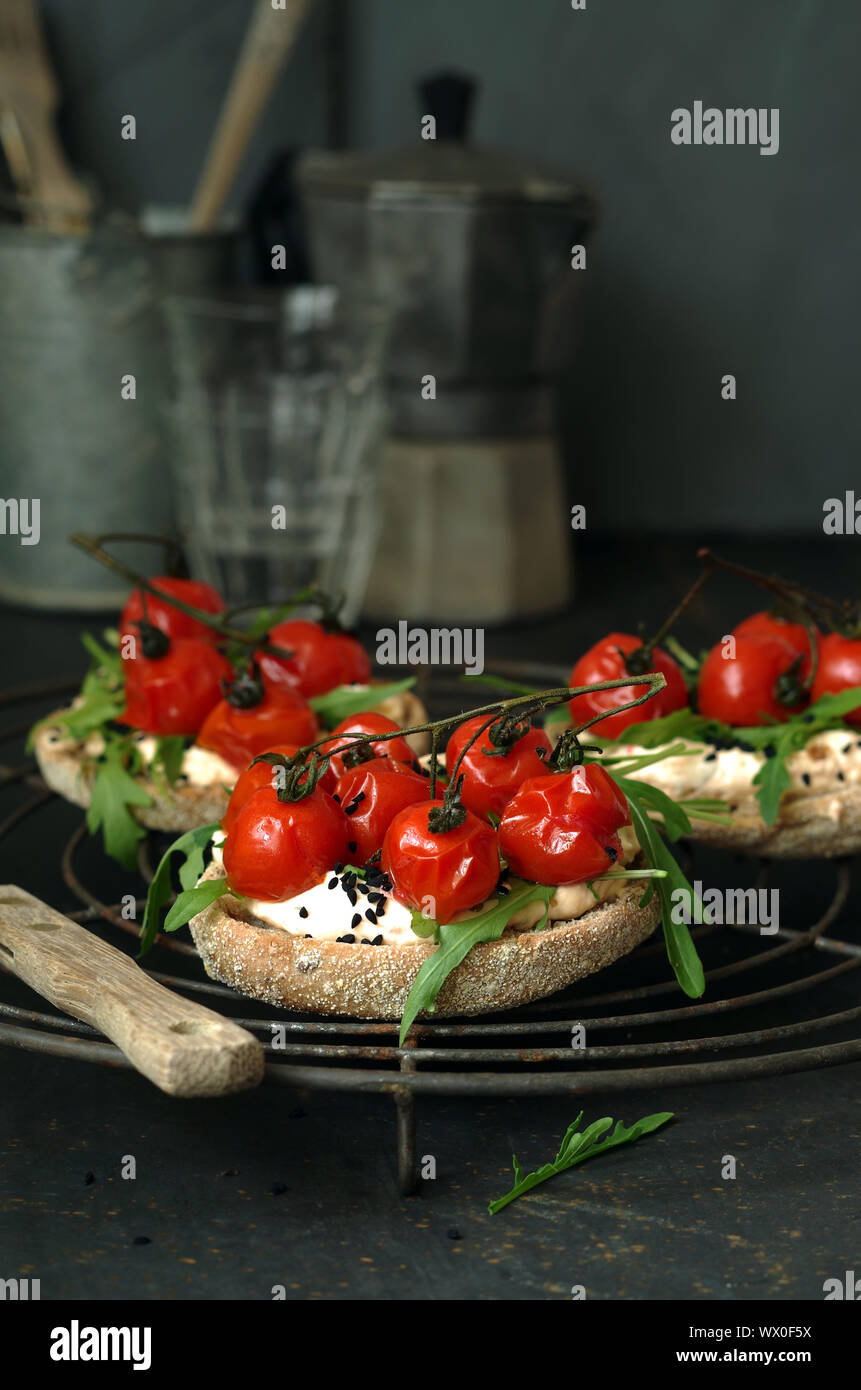 toast roll with cream cheese, rocket and tomatos Stock Photo - Alamy