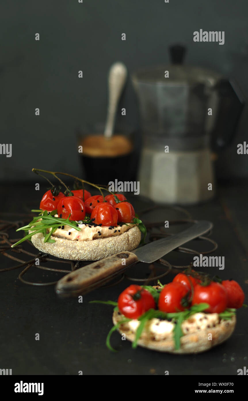 toast roll with cream cheese, rocket and tomatos Stock Photo - Alamy