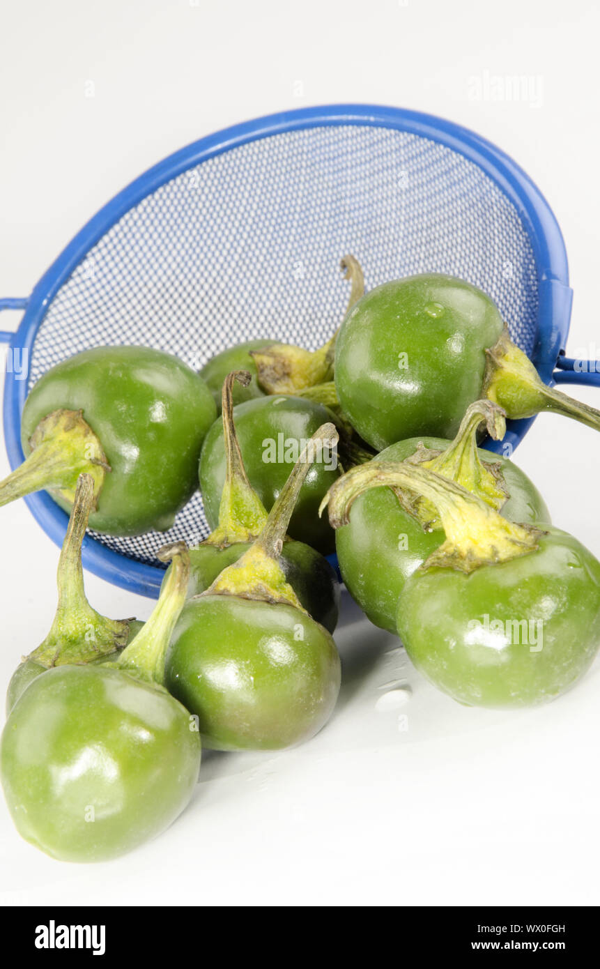 cherry peppers and a small blue sieve after cleaning Stock Photo - Alamy