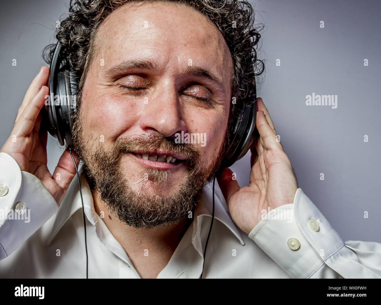 enjoy the music, man with intense expression, white shirt Stock Photo ...
