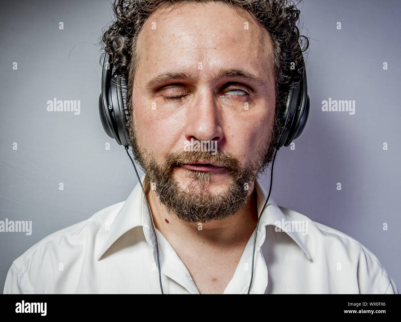 hate music, man with intense expression, white shirt Stock Photo - Alamy