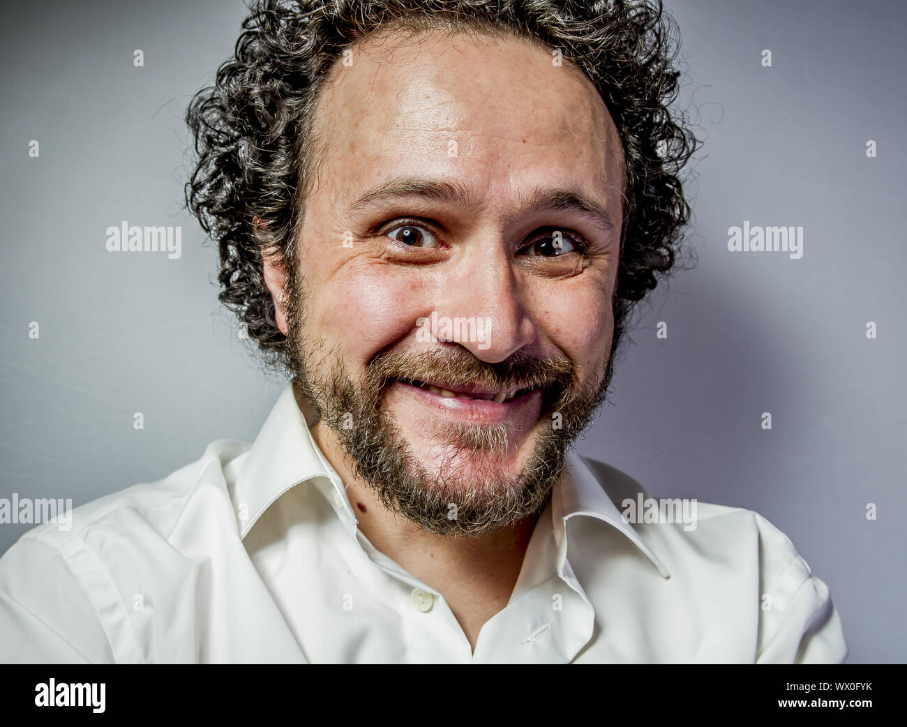 derision, man with intense expression, white shirt Stock Photo - Alamy