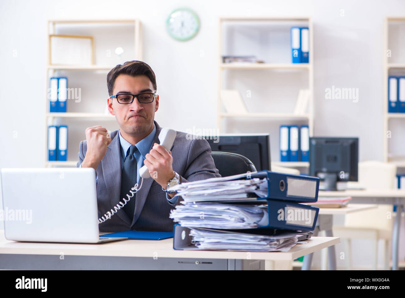 Desperate sad employee tired at his desk in call center Stock Photo - Alamy