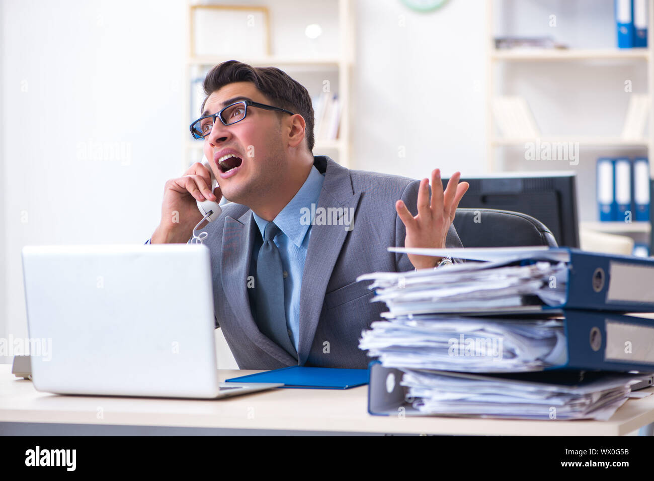 Desperate sad employee tired at his desk in call center Stock Photo - Alamy