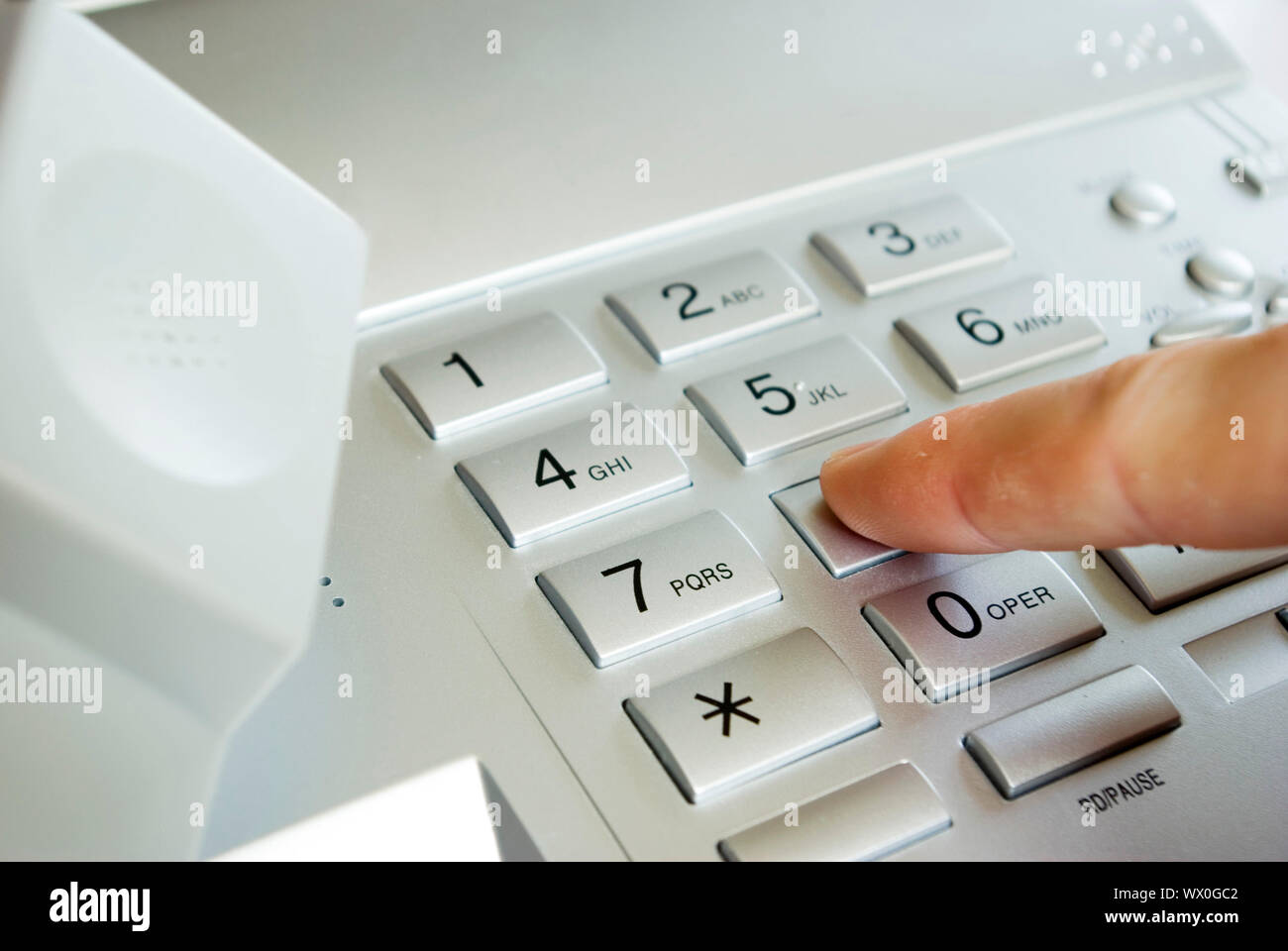 finger with grey telephone keypad Stock Photo - Alamy