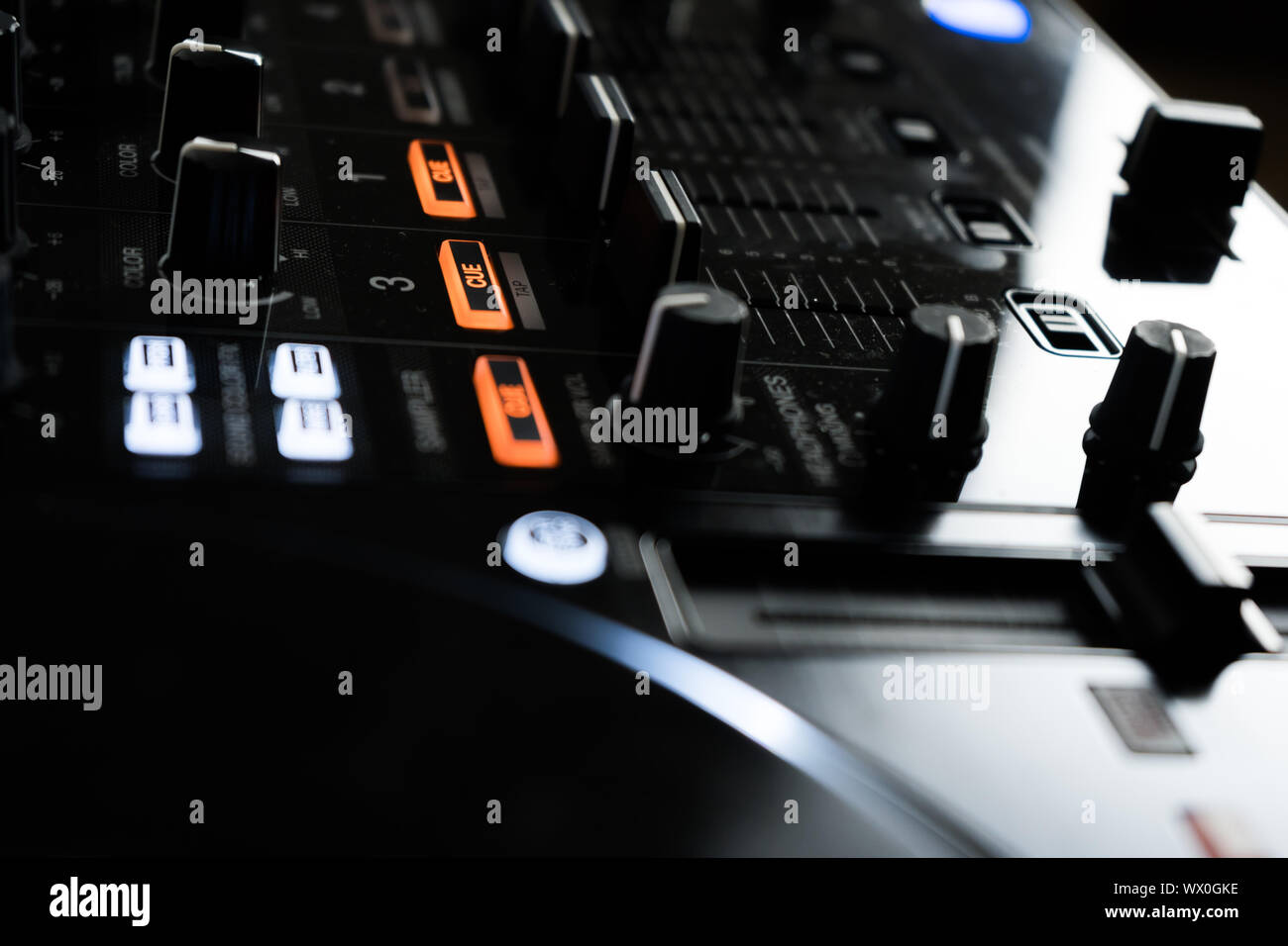 Wide angle photo of black sound mixer controller with knobs and sliders ...