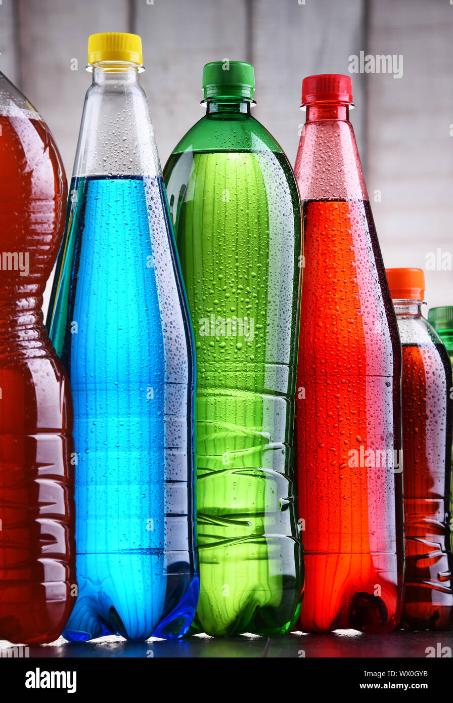 Plastic bottles of assorted carbonated soft drinks in variety of colors ...