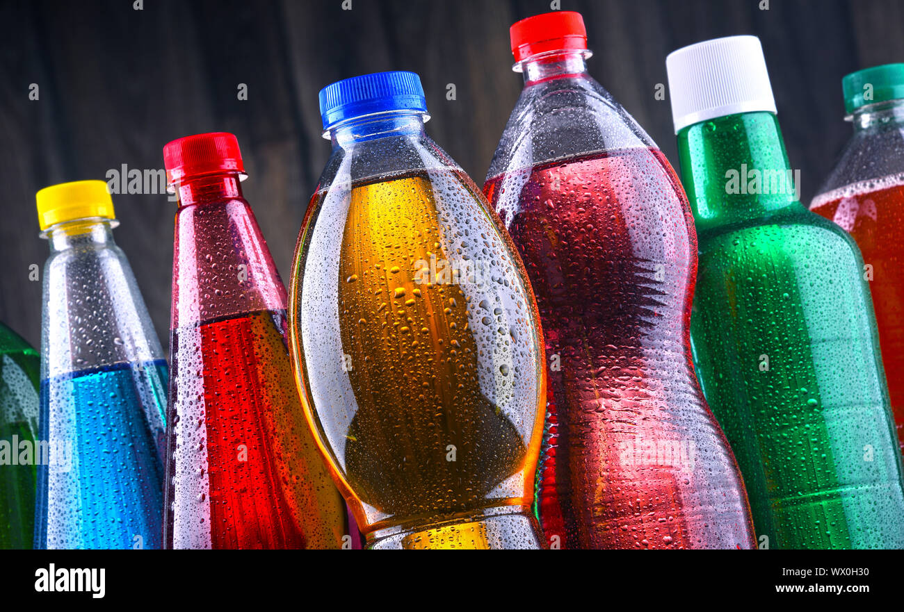 Plastic bottles of assorted carbonated soft drinks in variety of colors ...