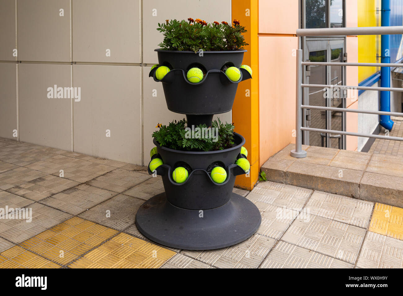 Street flower pot with tennis balls inside, the idea of decoration in ...
