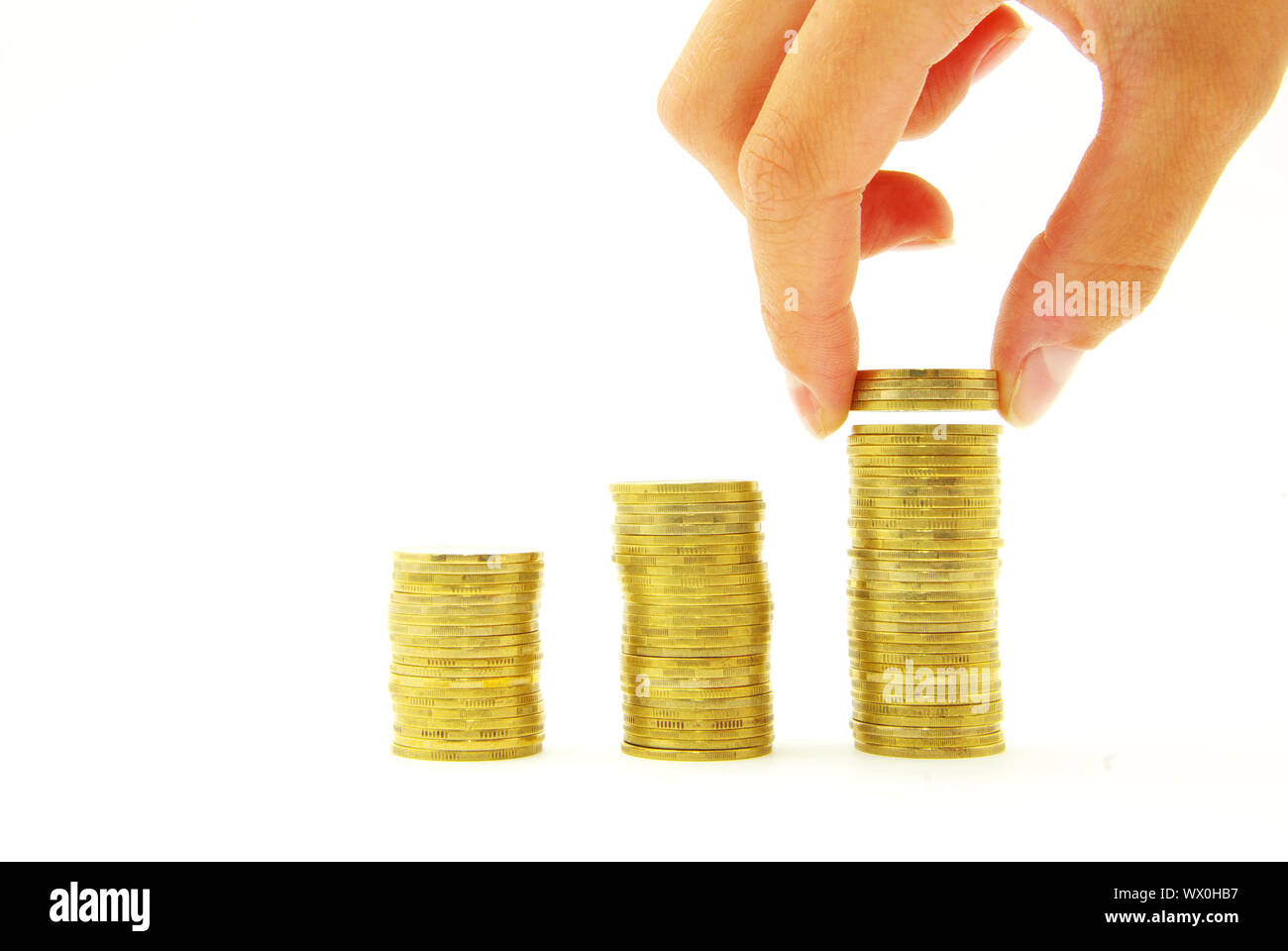 Hand put coin to money staircase isolated on white background Stock ...