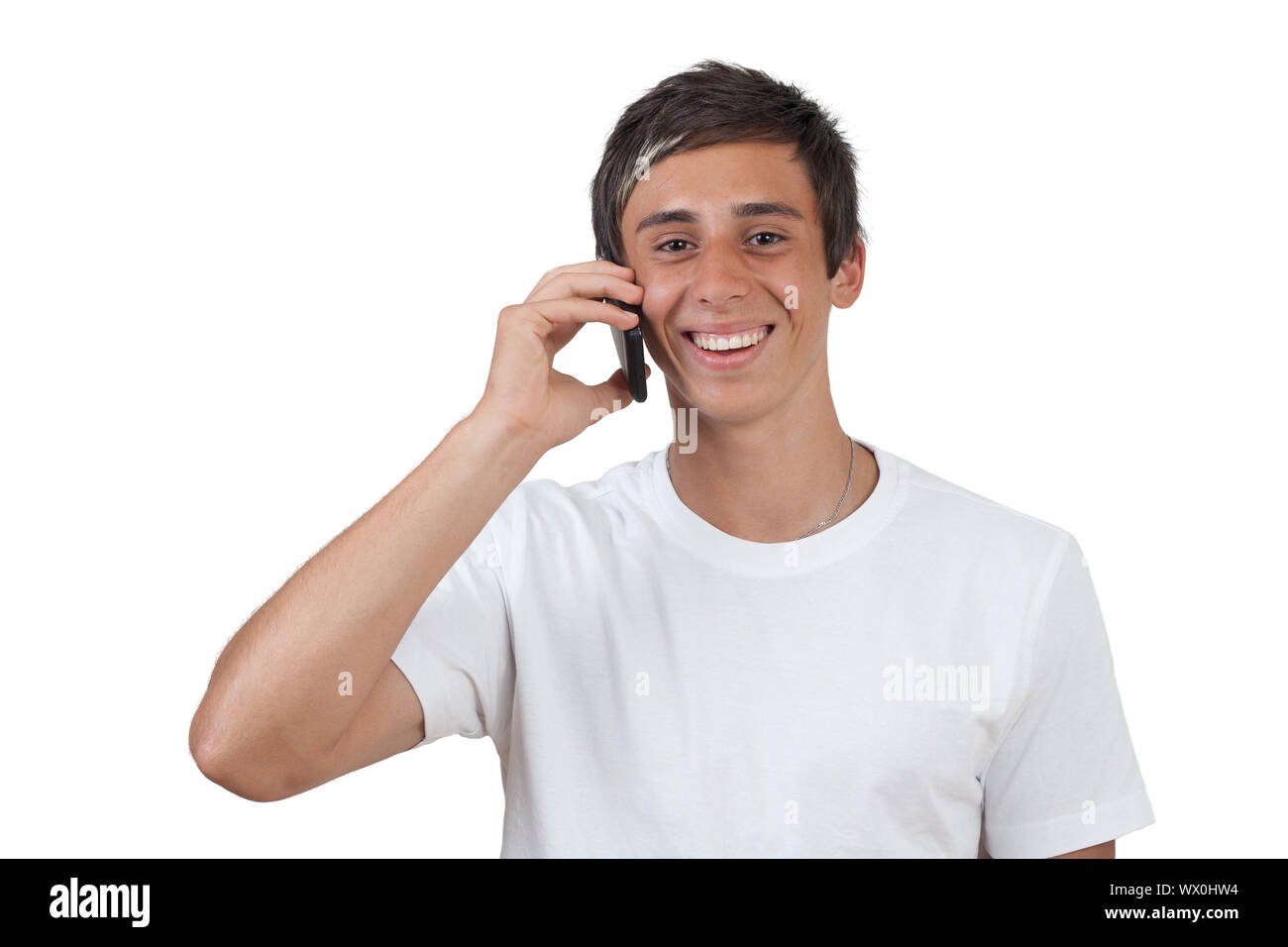 young swarthy man with brown eyes talking via cellphone to someone on ...