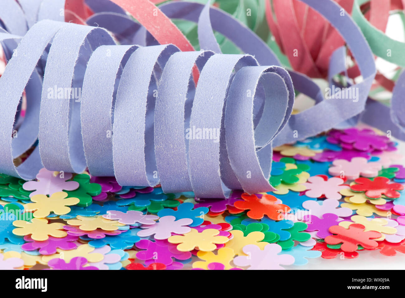 paper colorful party streamers on tiny flowers Stock Photo - Alamy