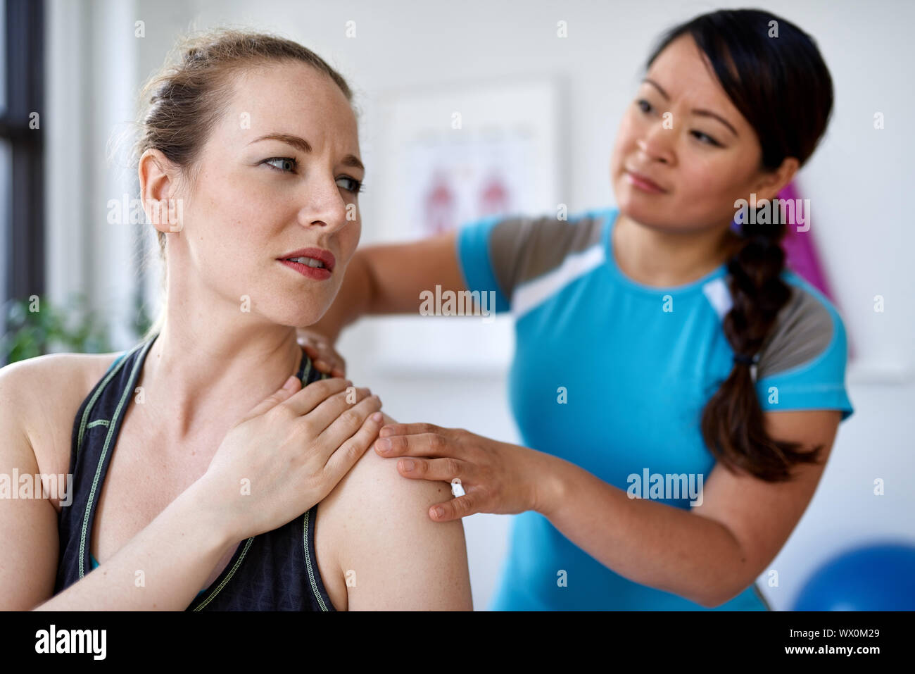 Chinese woman physiotherapy professional giving a treatment to an ...