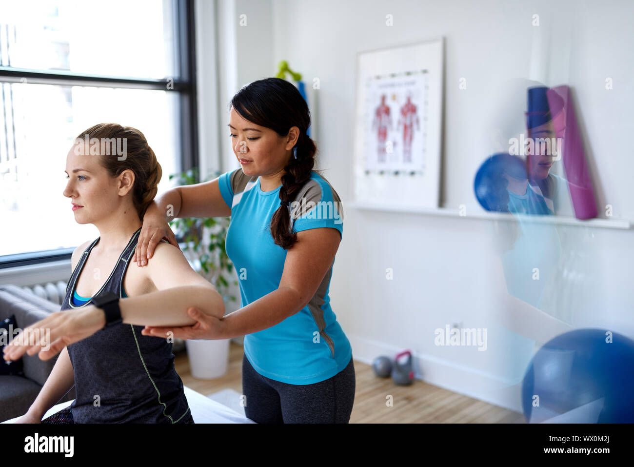 Chinese woman physiotherapy professional giving a treatment to an ...