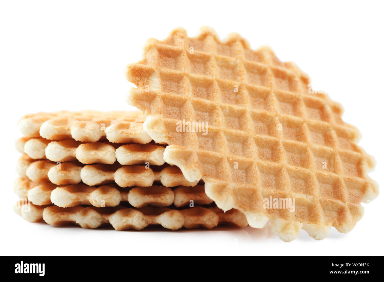 A stack of golden round waffles isolated over white background Stock ...