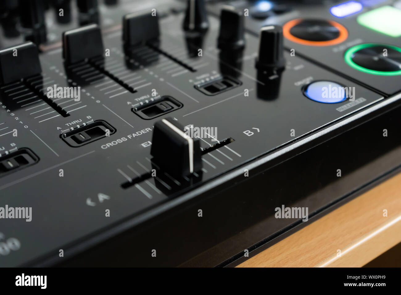 Wide angle photo of black sound mixer controller with knobs and sliders ...