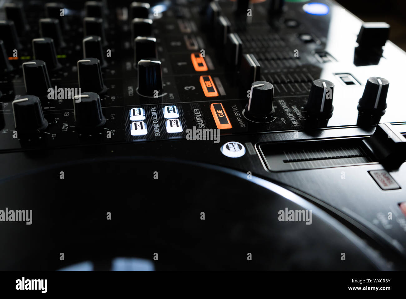 Wide angle photo of black sound mixer controller with knobs and sliders ...