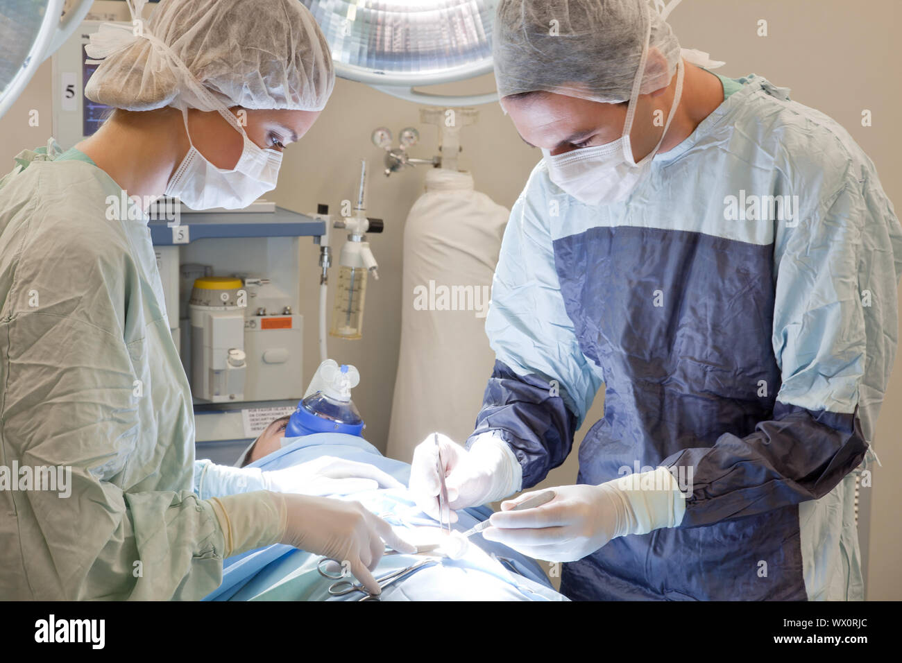 Doctor operating the patient in operation room in hospital Stock Photo ...