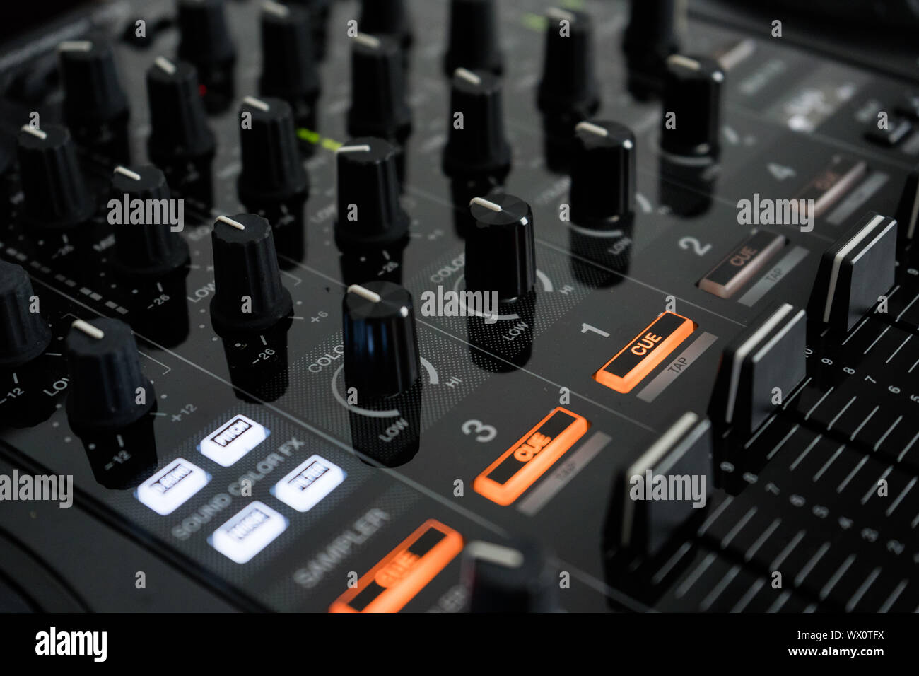 Wide angle photo of black sound mixer controller with knobs and sliders ...
