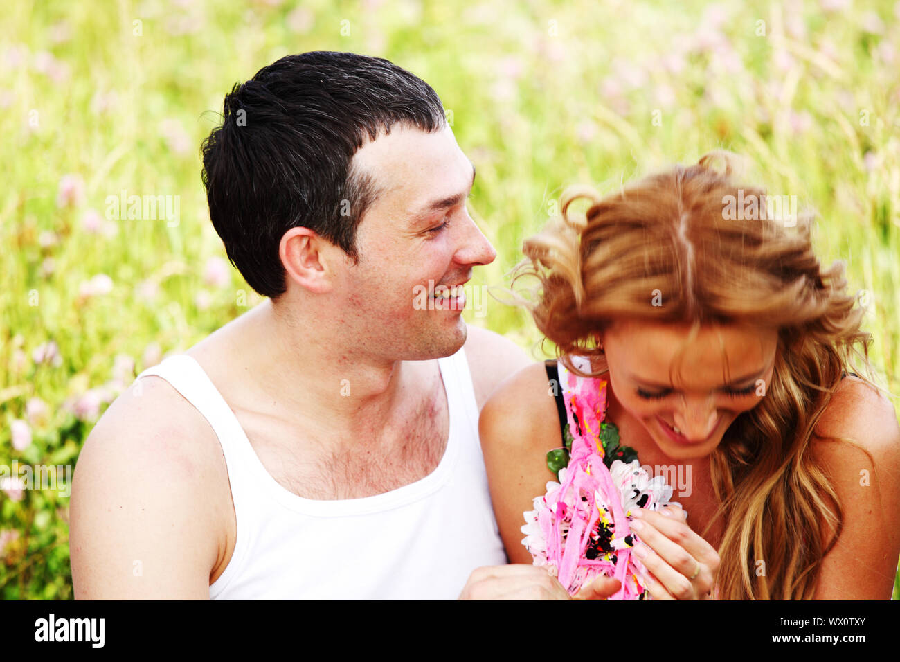 two lovers on grass field Stock Photo - Alamy