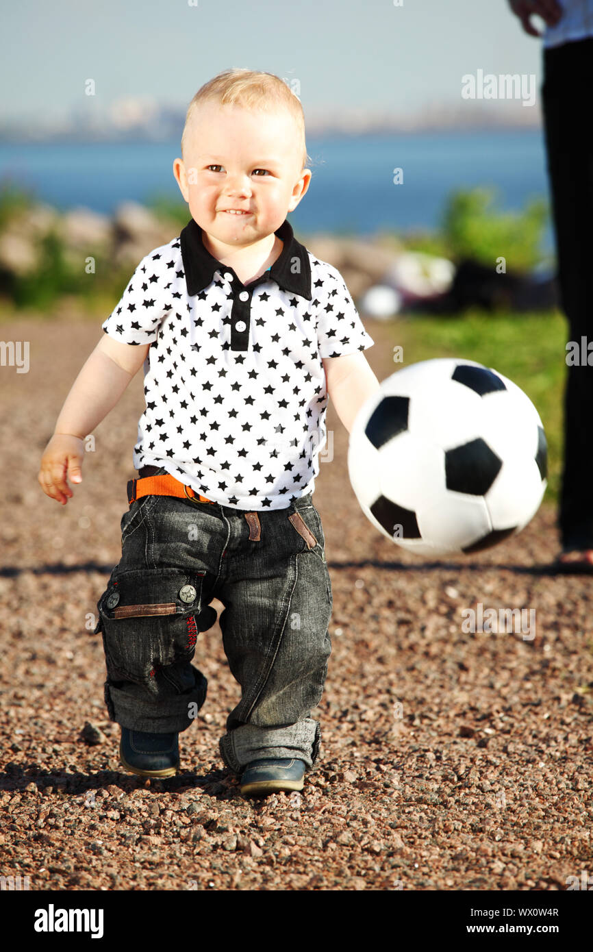 little boy play soccer outdoor Stock Photo - Alamy
