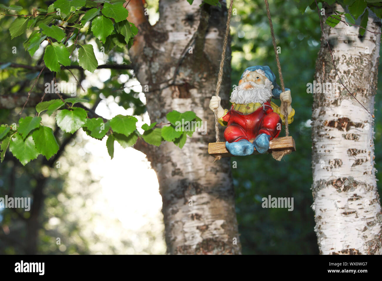 garden dwarf on green nature background Stock Photo - Alamy