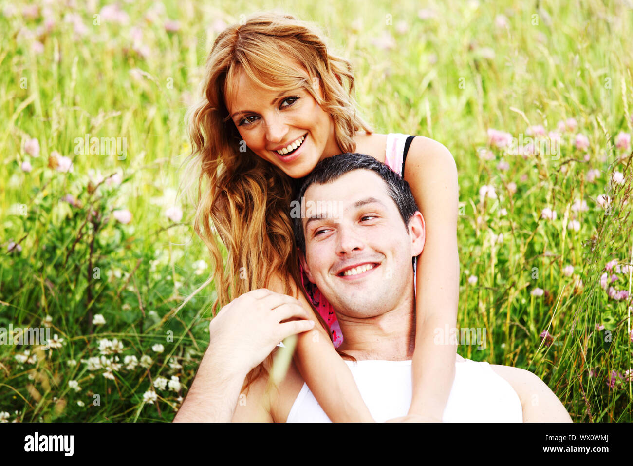 two lovers on grass field Stock Photo - Alamy