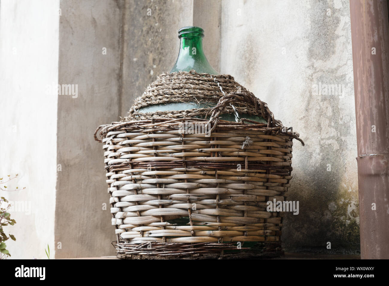 Empty carboy in rustic house Stock Photo - Alamy