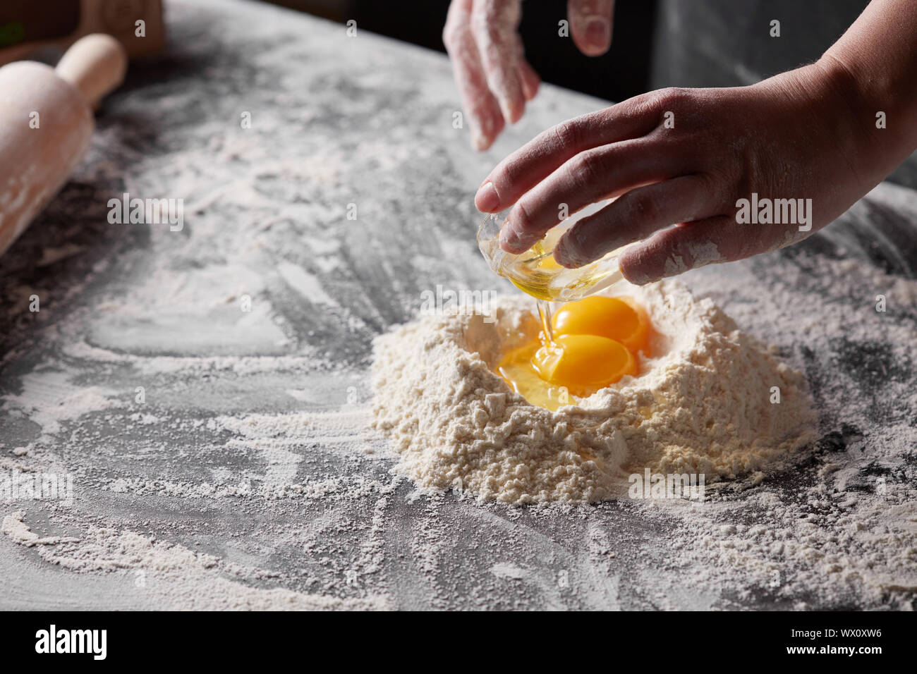 women's hands is cooking dough for baking on a kitchen table Stock ...