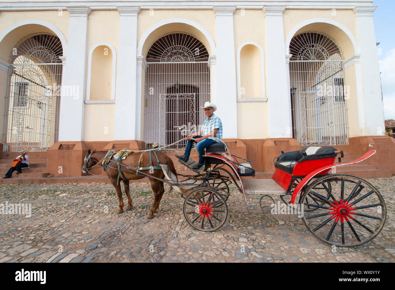 Horse and carriage in the Plaza Mayor and Church of the Holy Trinity ...