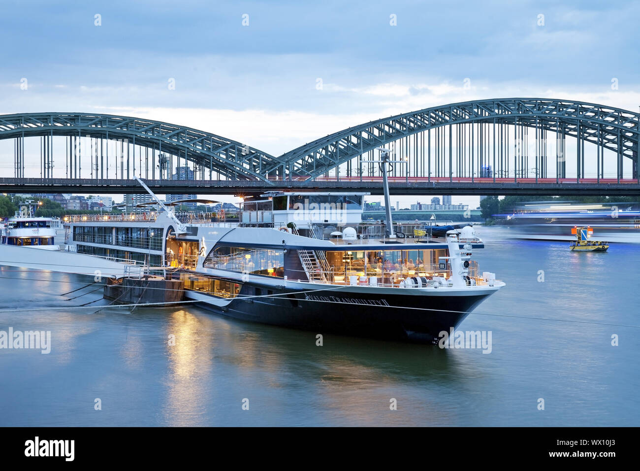 ships on Rhine river and Hohenzollern Bridge in the evening, Cologne ...