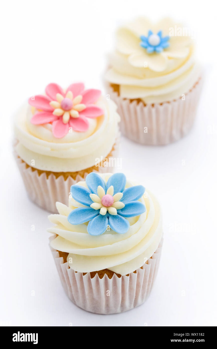 Three flower cupcakes isolated against white Stock Photo - Alamy
