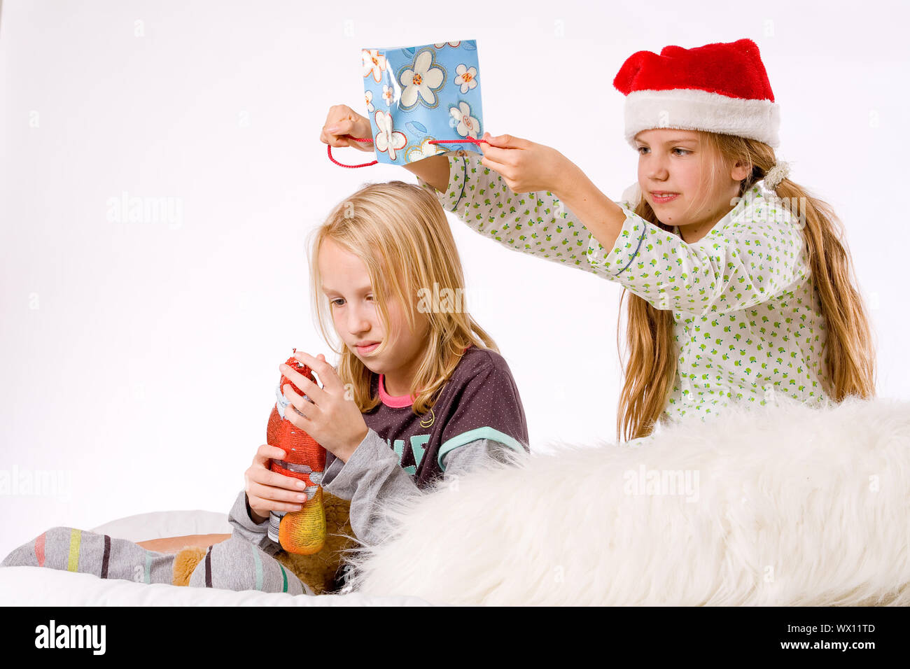 Two children having a fight about the present Stock Photo - Alamy