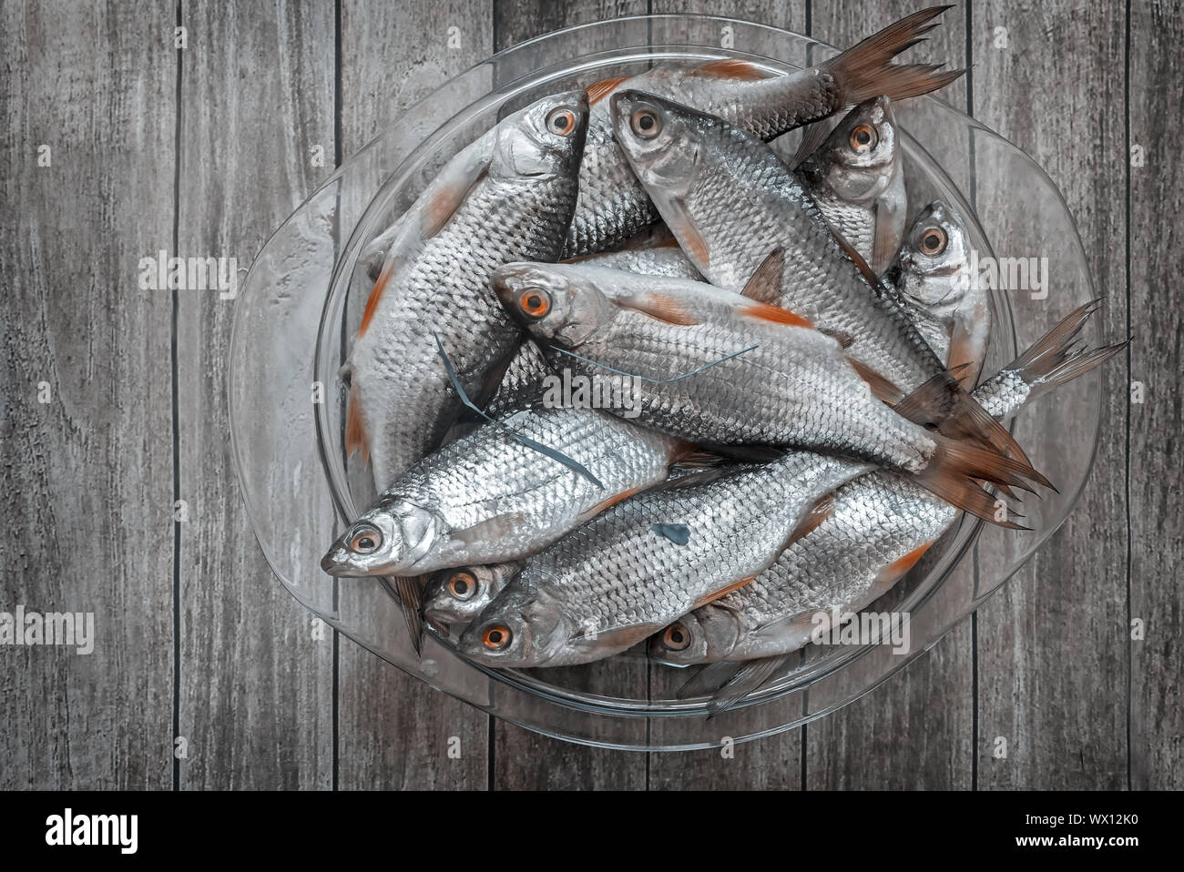Fresh fish on the table in a glass dish Stock Photo - Alamy