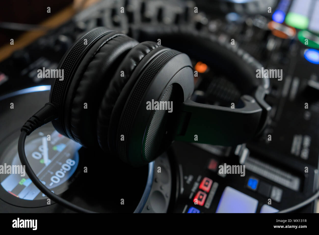 Professional dj headphones on audio mixer controller Stock Photo - Alamy