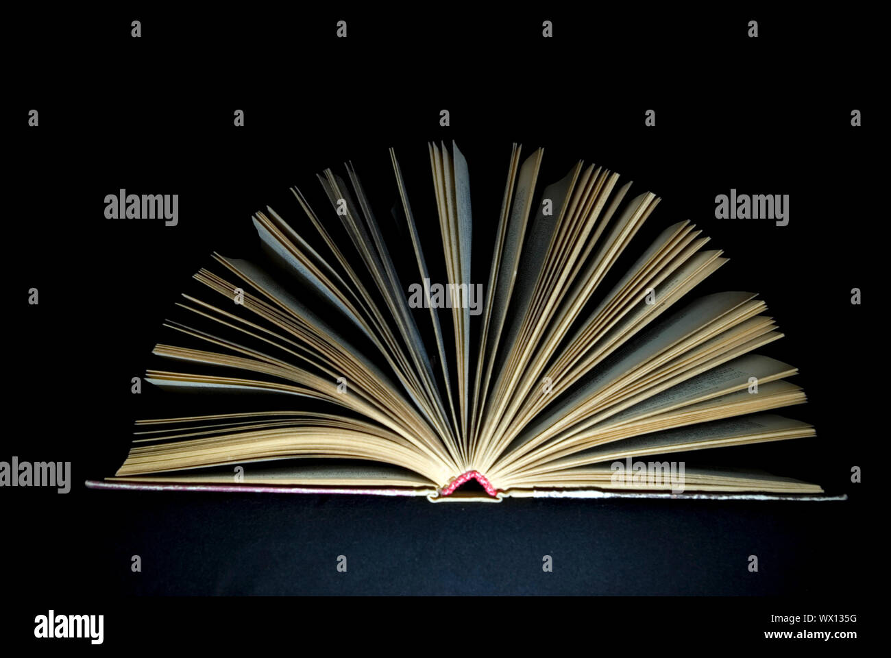 open book on black background Stock Photo - Alamy