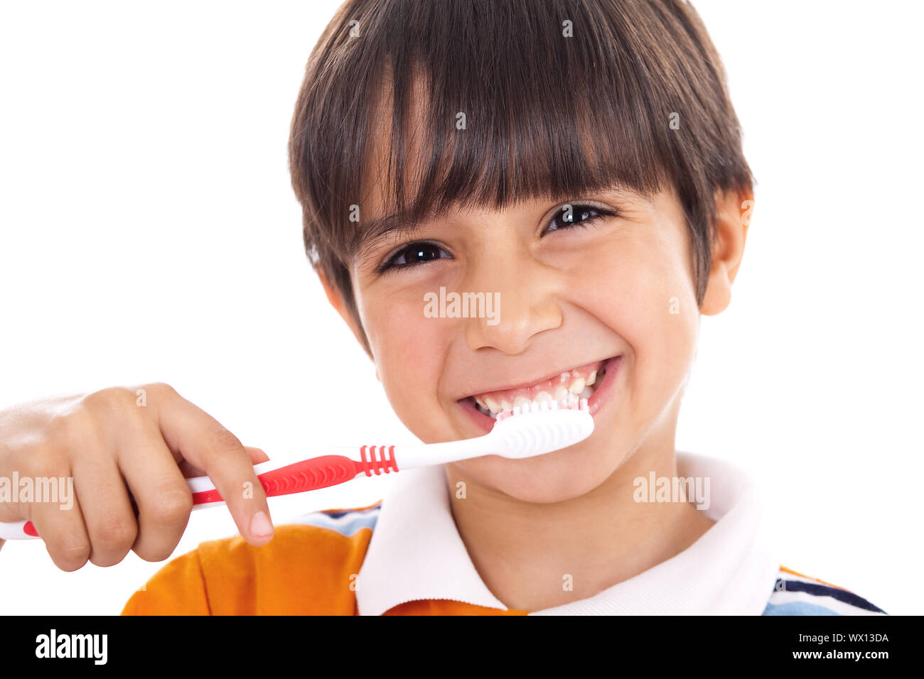 Closeup of cute kid brushing his teeth on isolated white background ...
