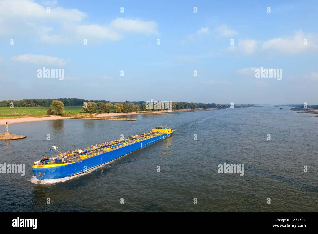 River landscape with big blue boat Stock Photo - Alamy